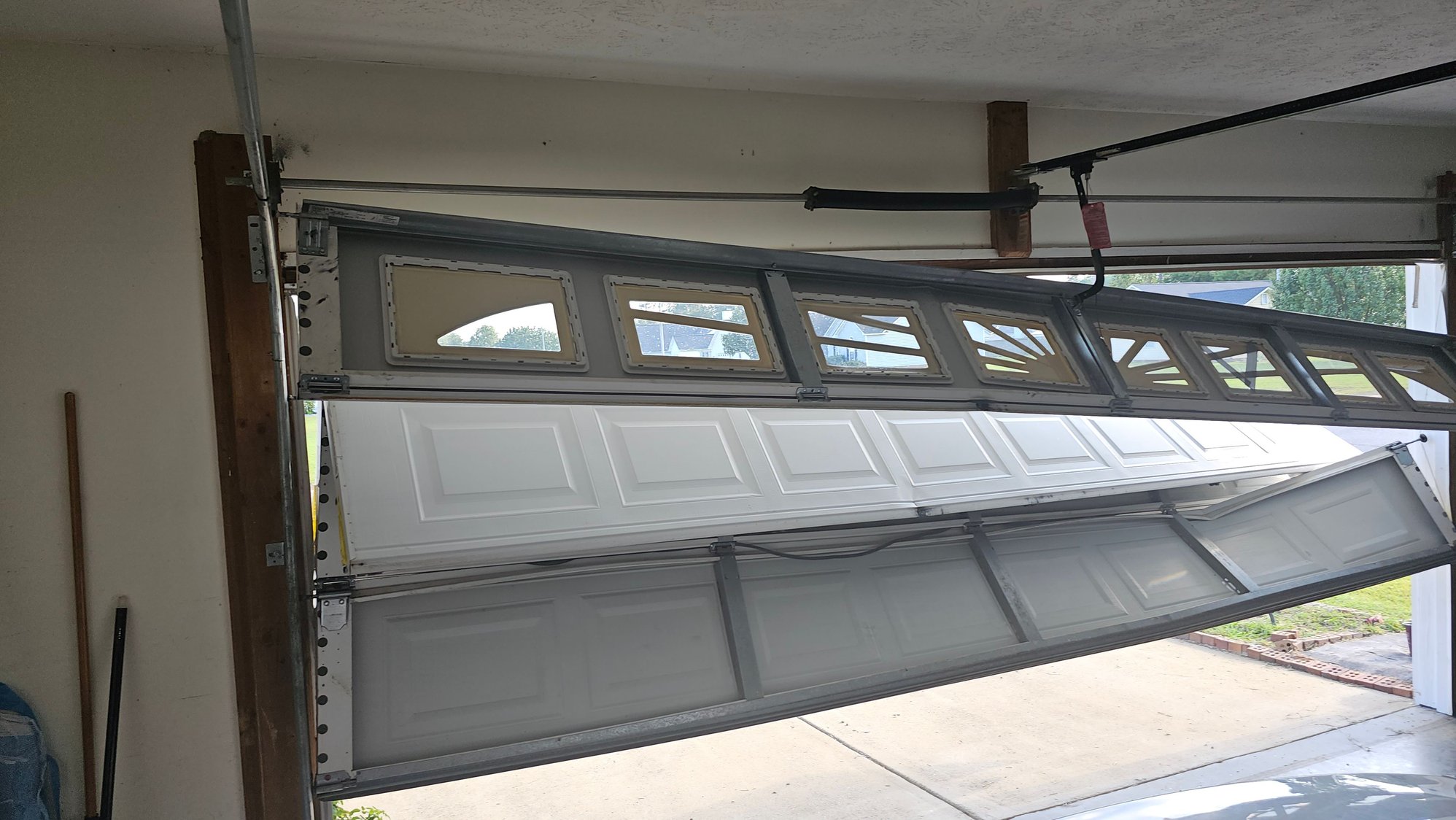 Older type plastic riveted hinge garage door folded on itself ...